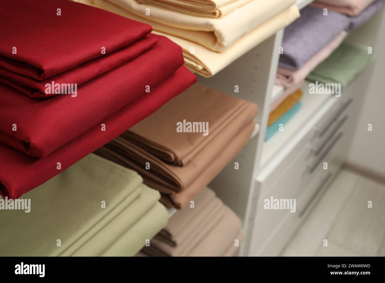 Different colorful bed linens on display in shop, closeup Stock Photo ...