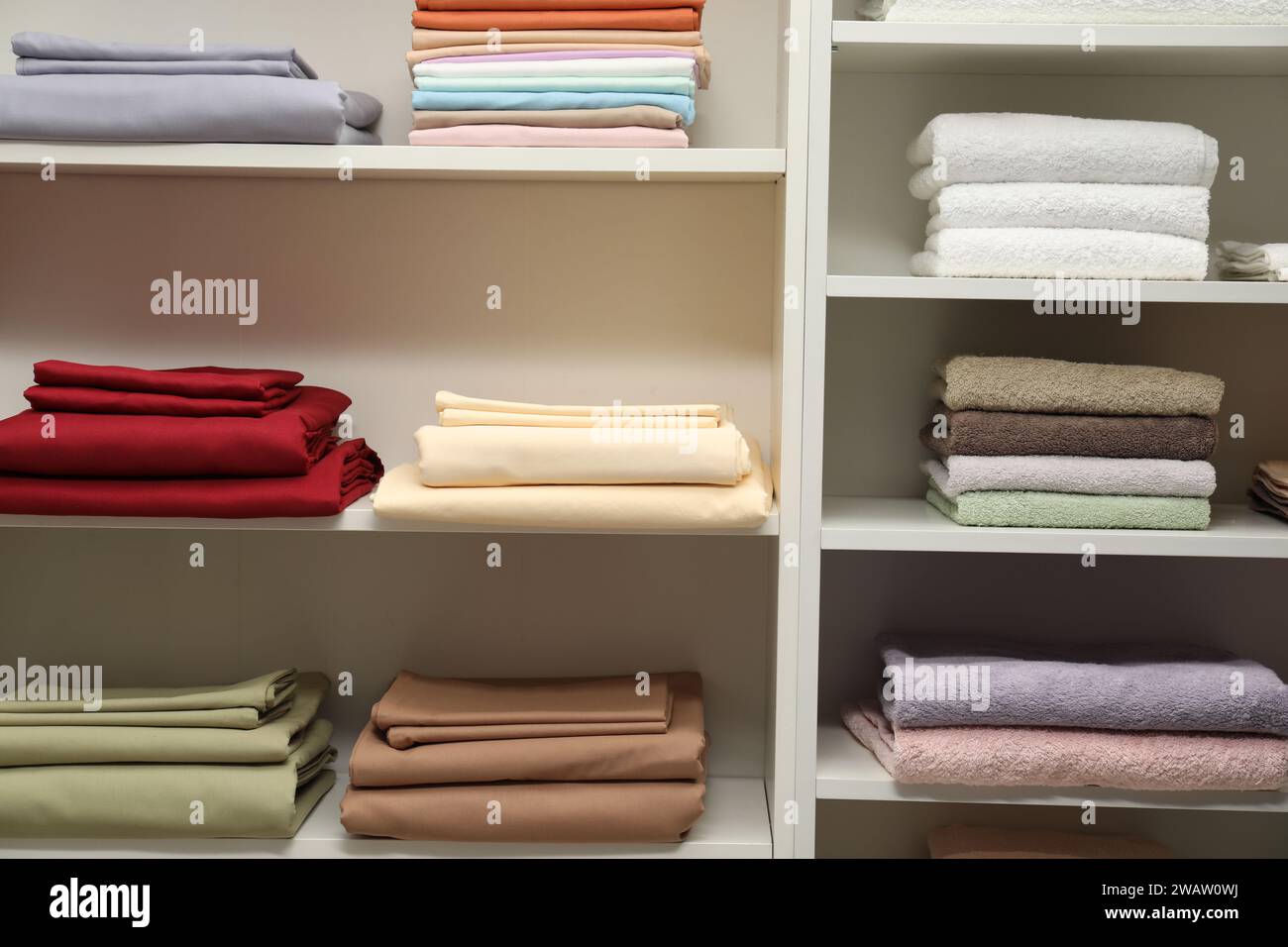 Different colorful bed linens on display in home textiles store Stock ...