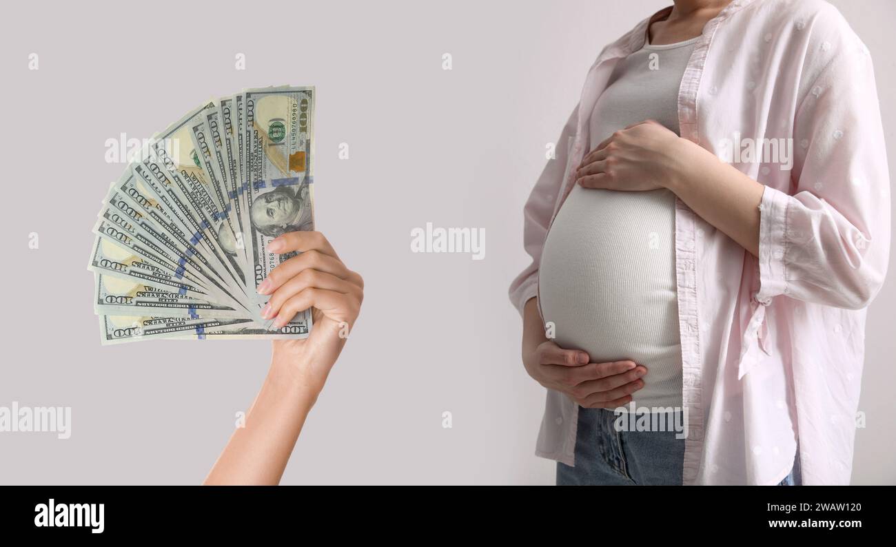 Surrogacy. Intended mother with money and pregnant woman on light ...