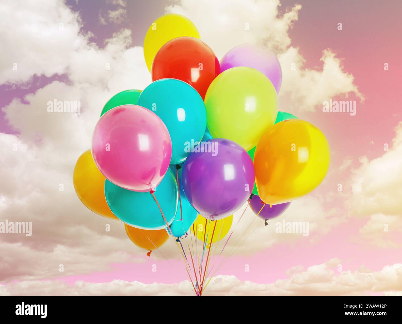 Bunch of colorful balloons flying in pink sky with clouds, color toned ...