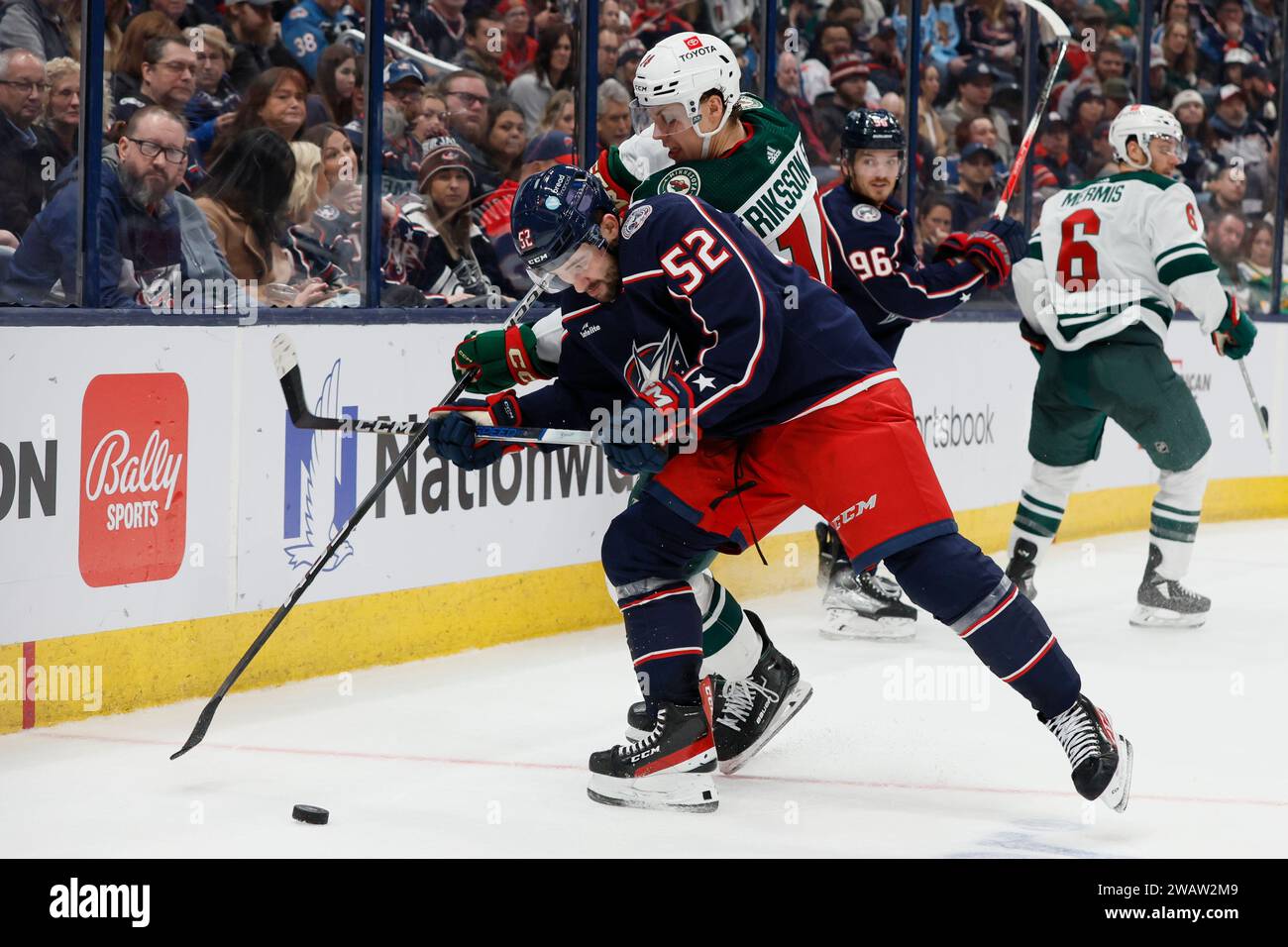 Columbus Blue Jackets' Emil Bemstrom, front, and Minnesota Wild's Joel ...