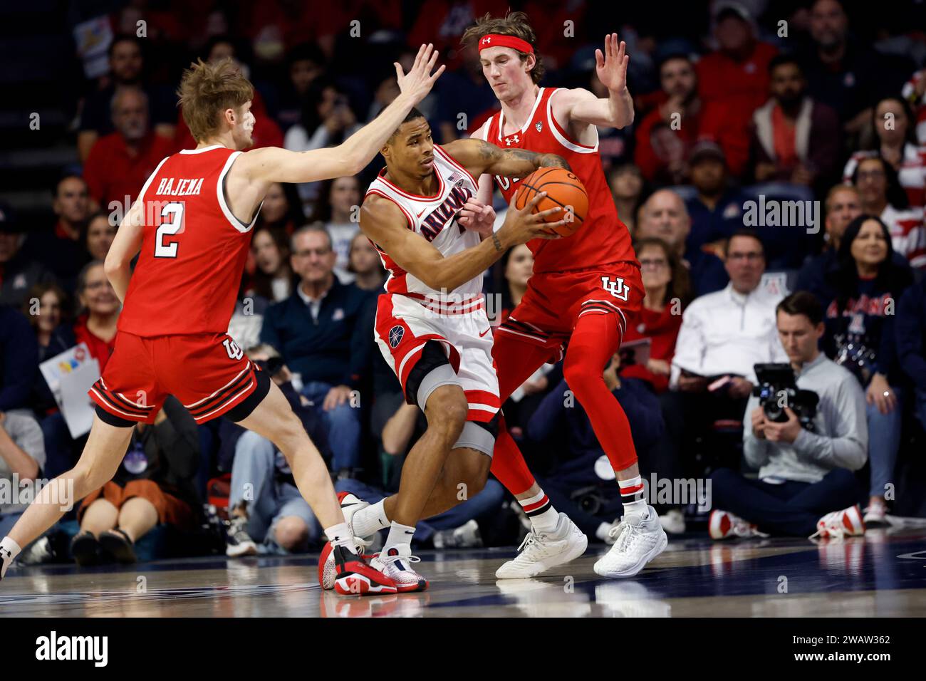 Arizona forward Keshad Johnson drives between Utah guard Cole Bajema ...