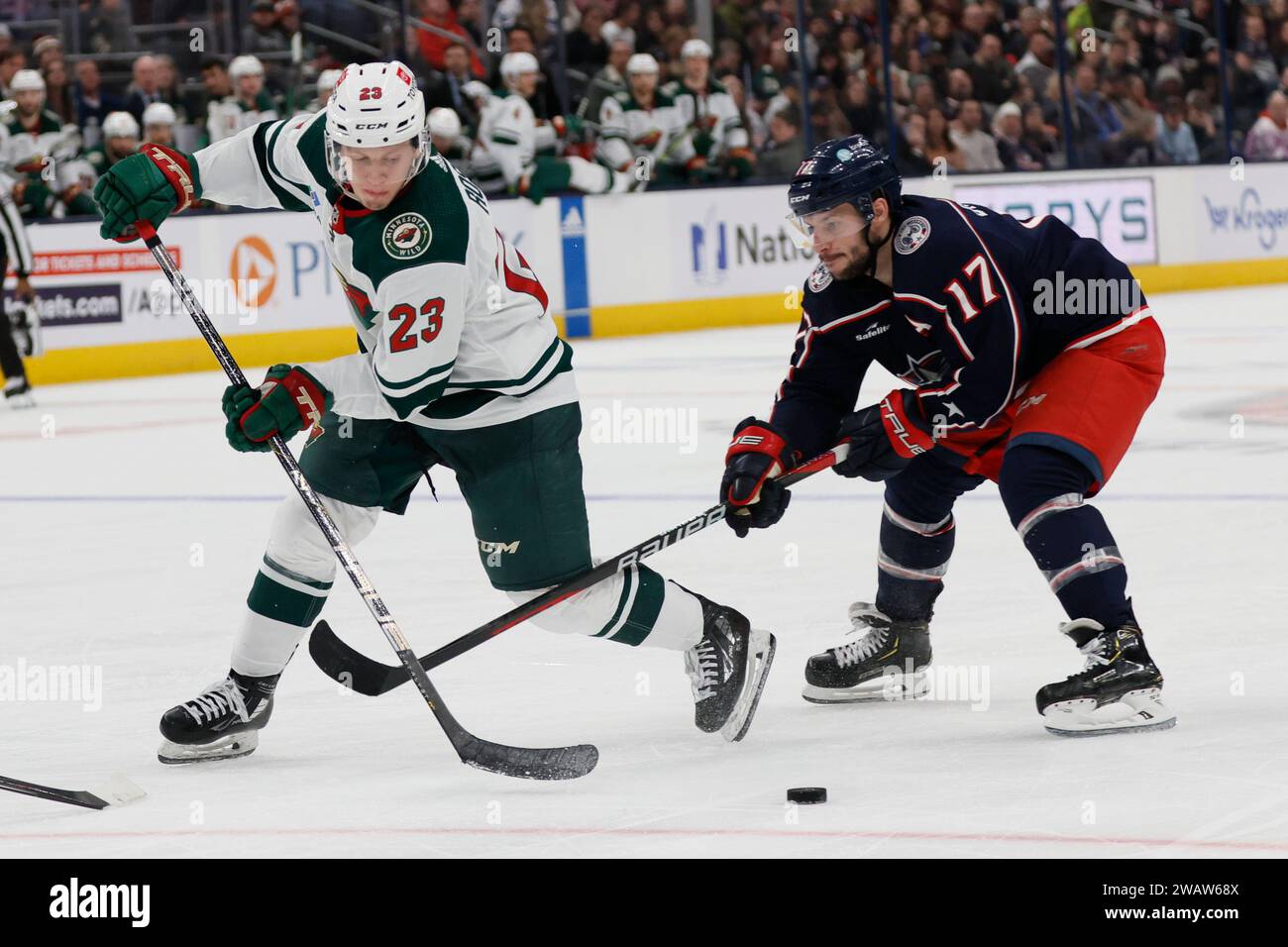 Columbus Blue Jackets' Justin Danforth, right, knocks the puck away ...