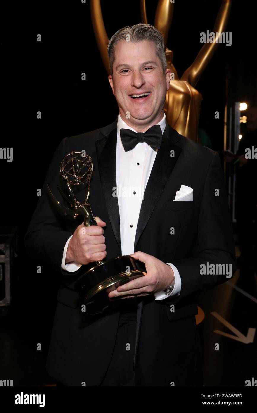 EXCLUSIVE - Chris Poulos poses the Emmy for outstanding picture editing ...