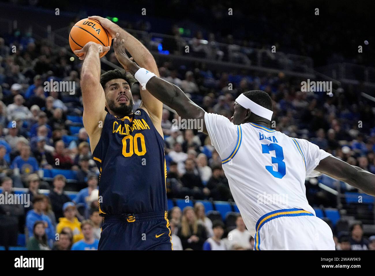California forward Fardaws Aimaq, left, shoots as UCLA forward Adem ...