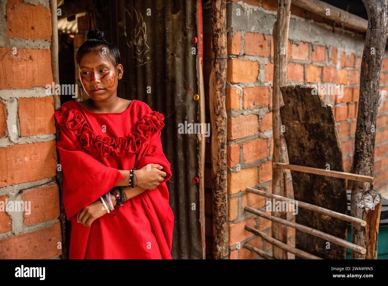 A Wayuu girl wearing a traditional cloth waits for her turn to take ...