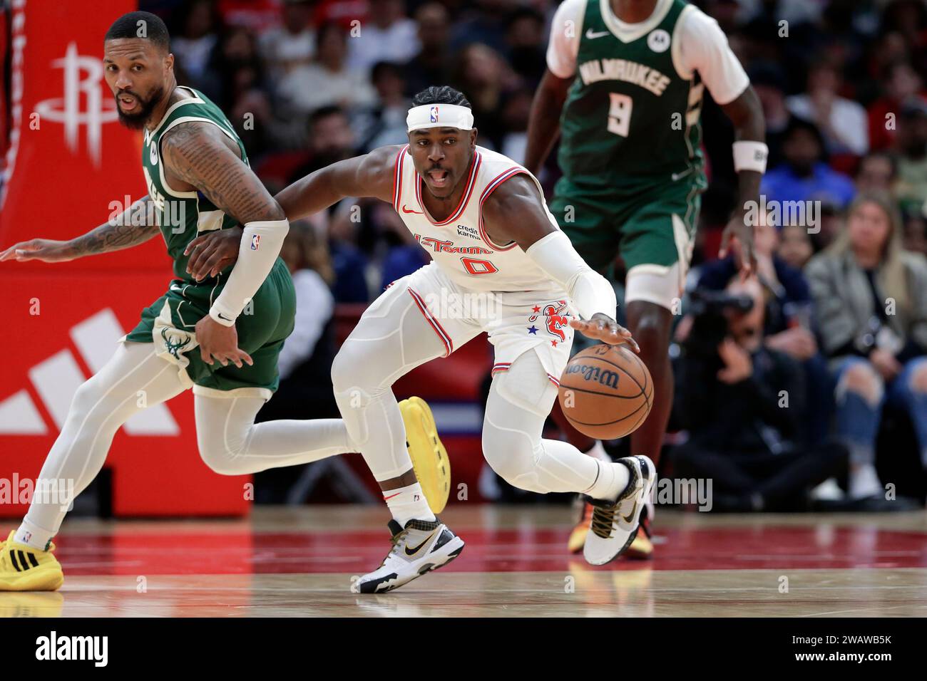 Houston Rockets guard Aaron Holiday, front right, recovers the ball in ...