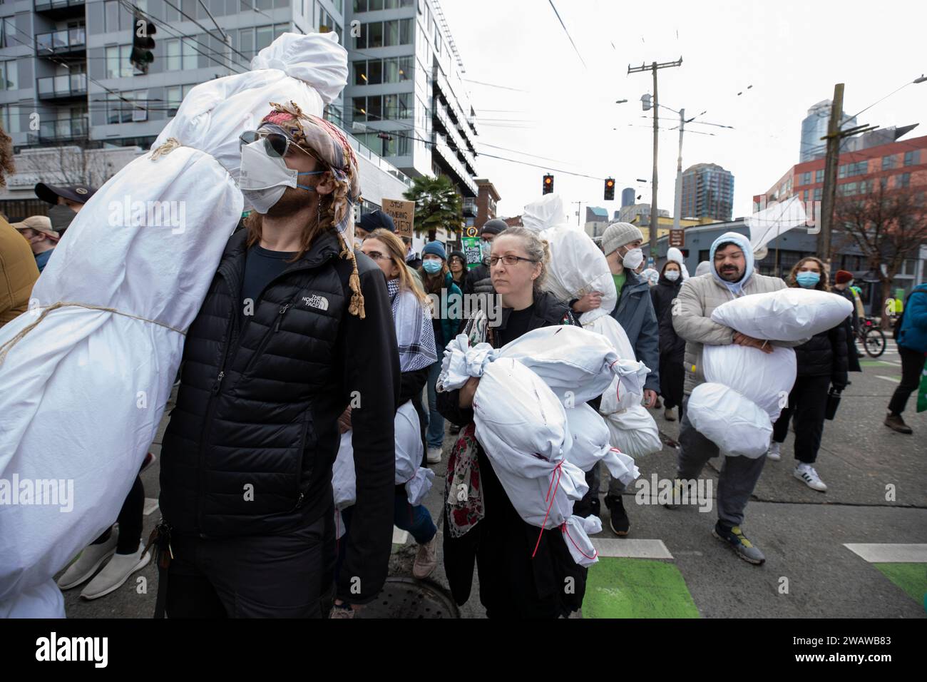 Seattle, Washington, USA. 6th January, 2024. Protestors hold shrouded ...
