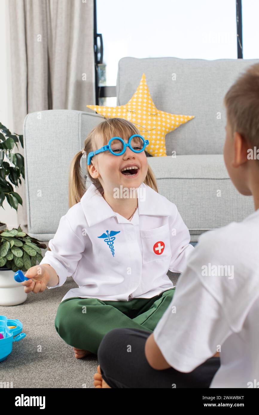 Brother and sister are playing at the hospital. A cute girl is playing ...