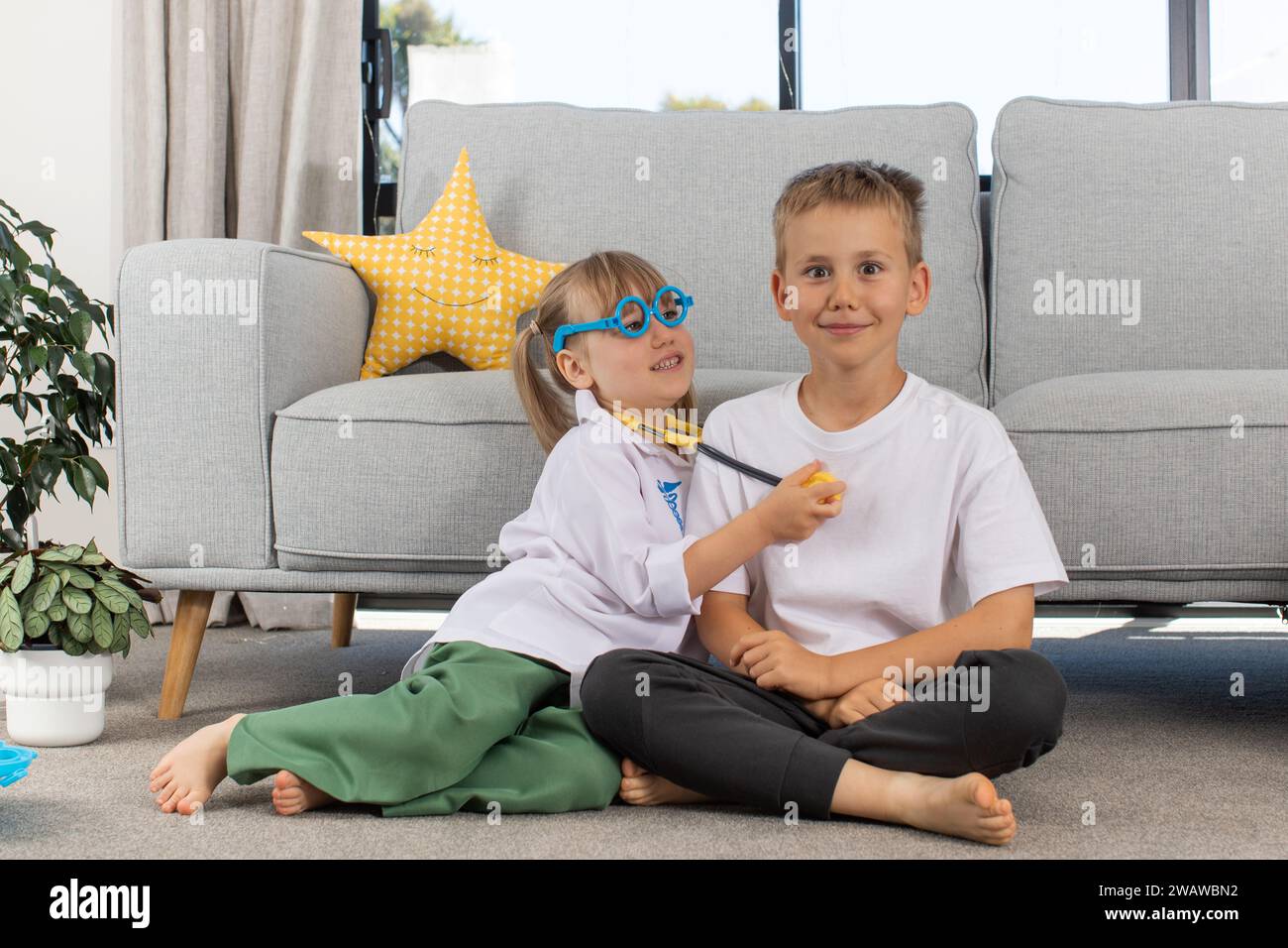 Brother and sister are playing at the hospital. A cute girl is playing ...