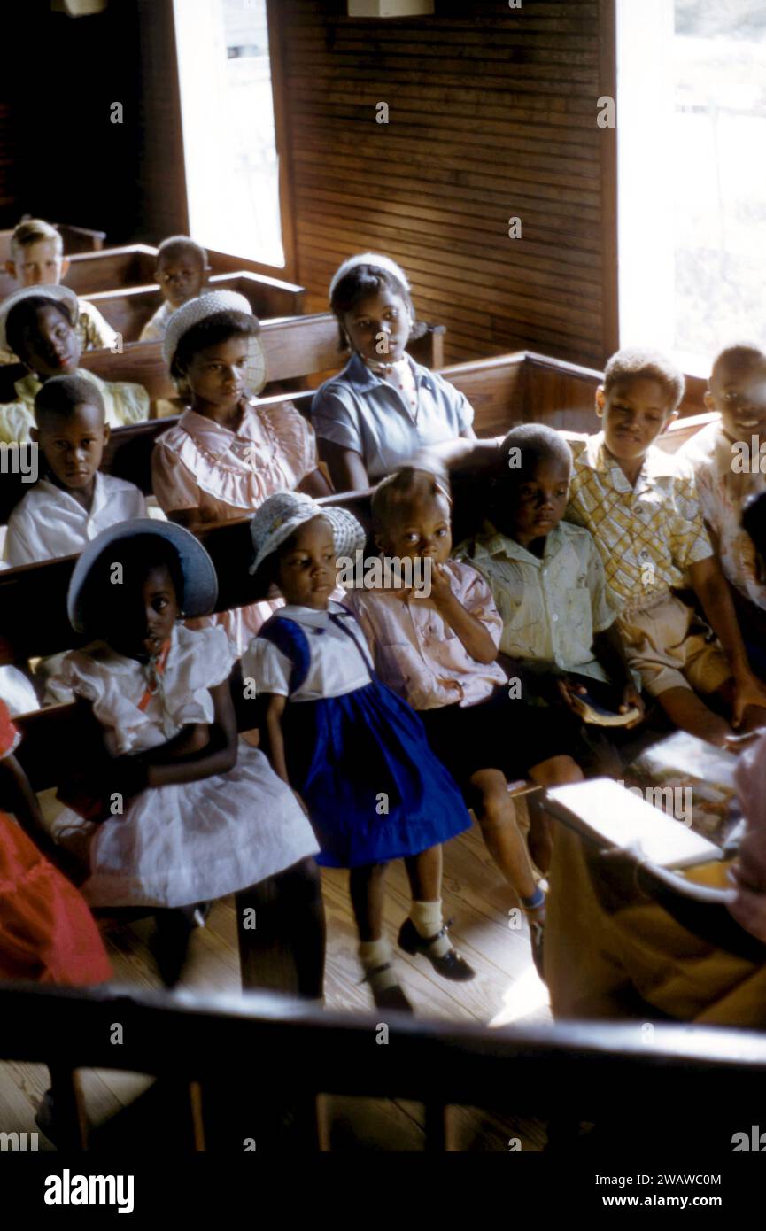 GREEN TURTLE CAY, ABACO, BAHAMAS - APRIL 28: Young children sit in a ...