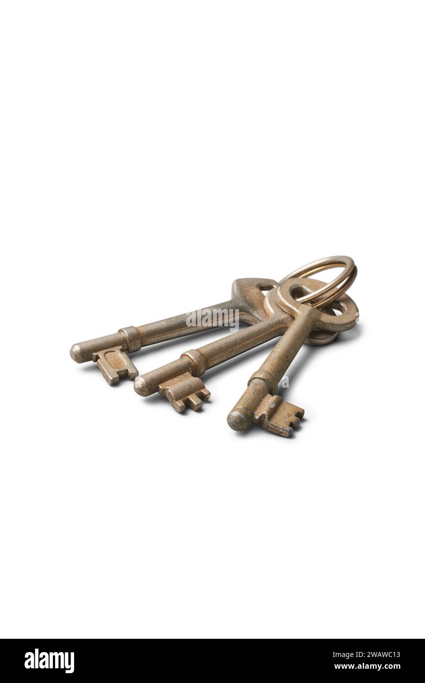 bunch of old door keys, three used metallic silver house keys isolated ...