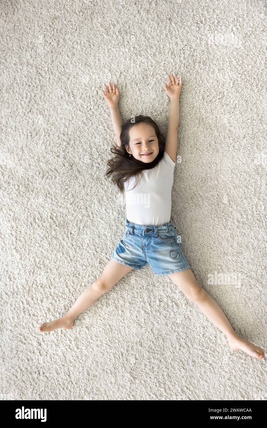 Top view girl having fun lying on carpet at home Stock Photo - Alamy