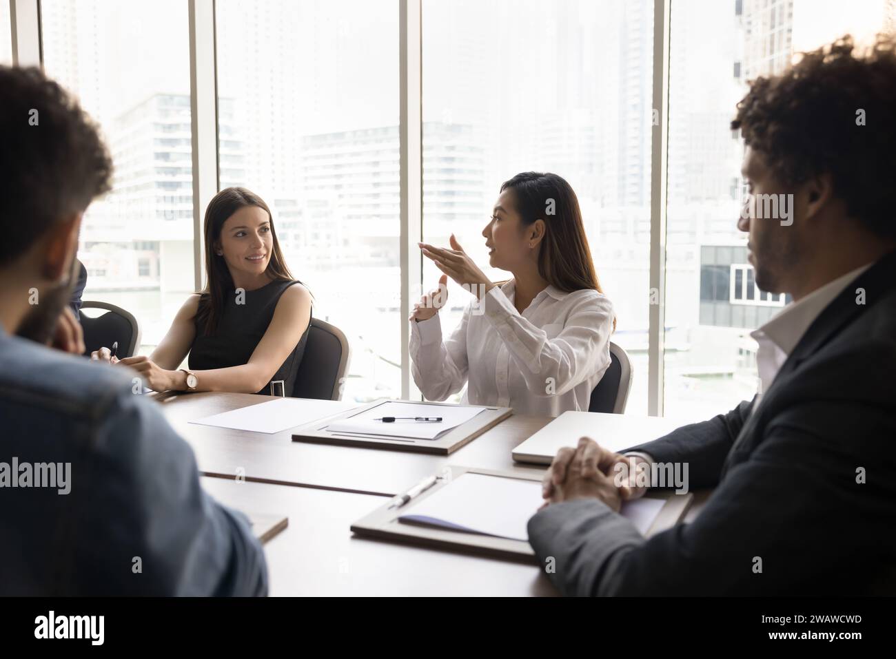 Engaged young Asian professional woman brainstorming on project Stock ...