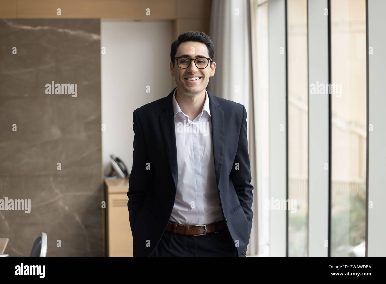 Happy young Arab company CEO man standing at workplace Stock Photo - Alamy