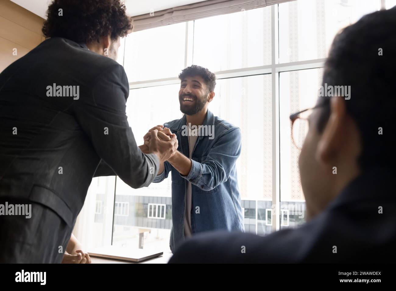 Positive excited project managers celebrating team success Stock Photo ...