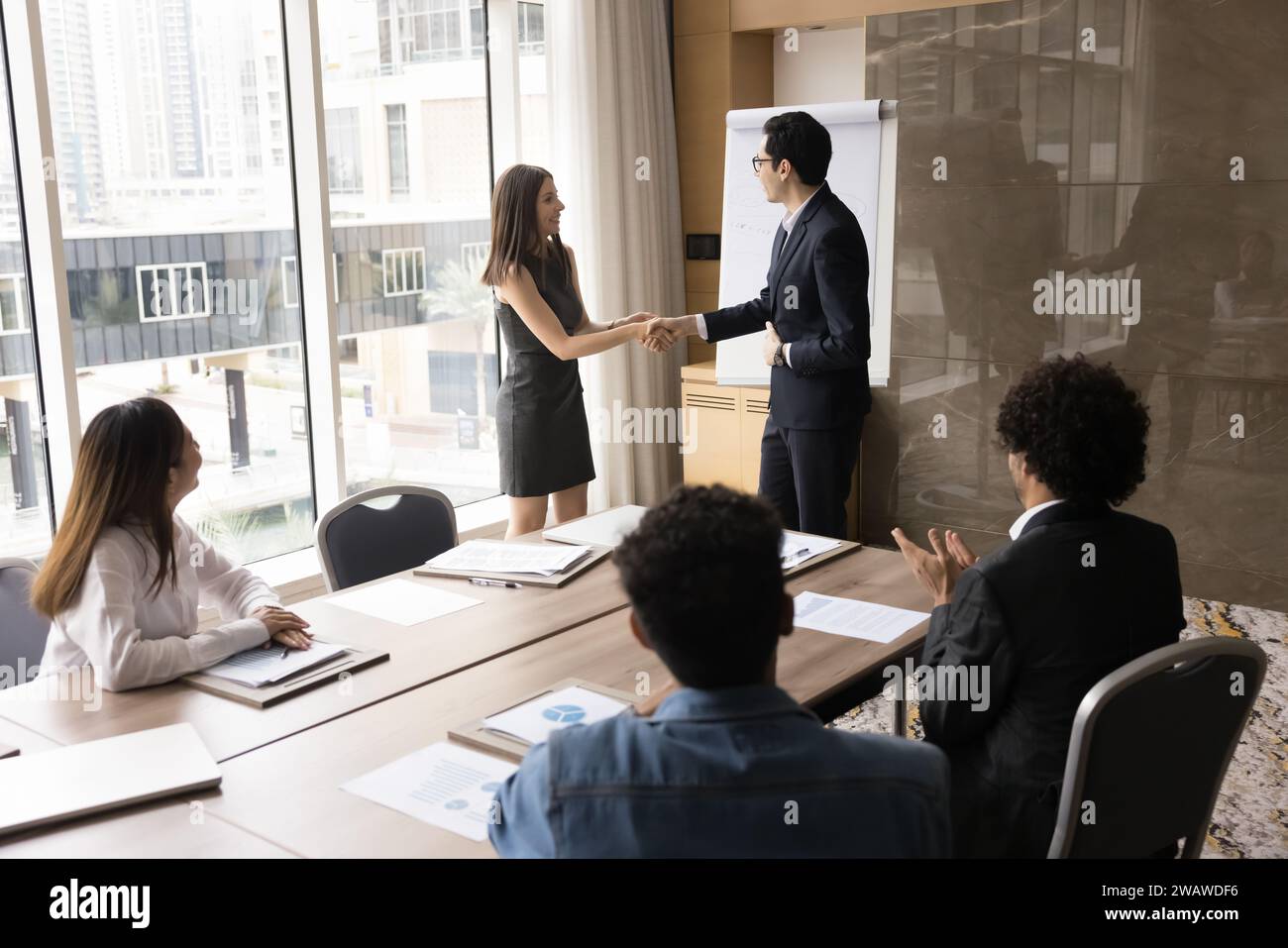 Successful young employee woman getting shaking hands with boss Stock ...