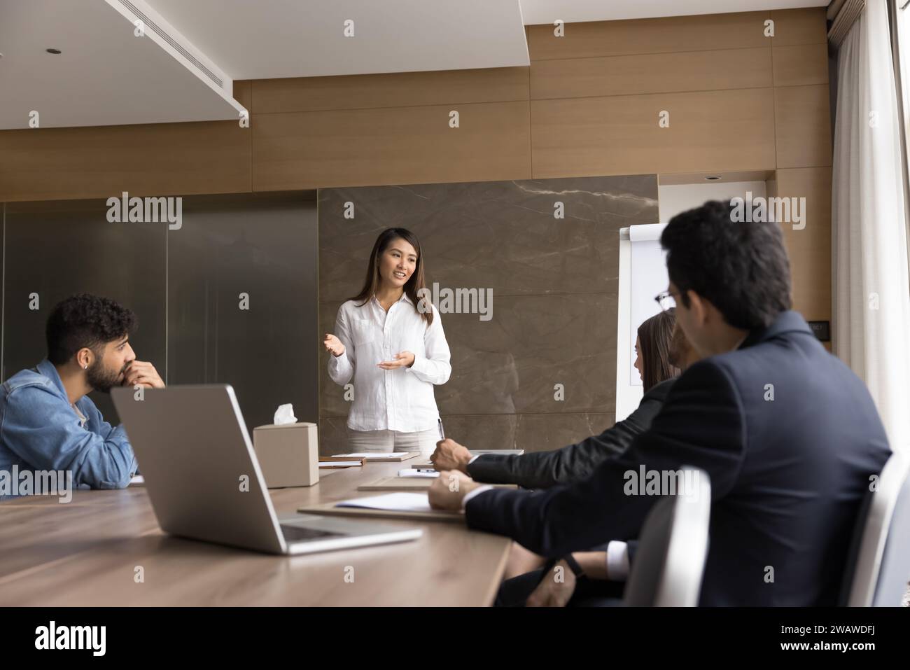Positive Asian project manager woman presenting marketing ideas to ...
