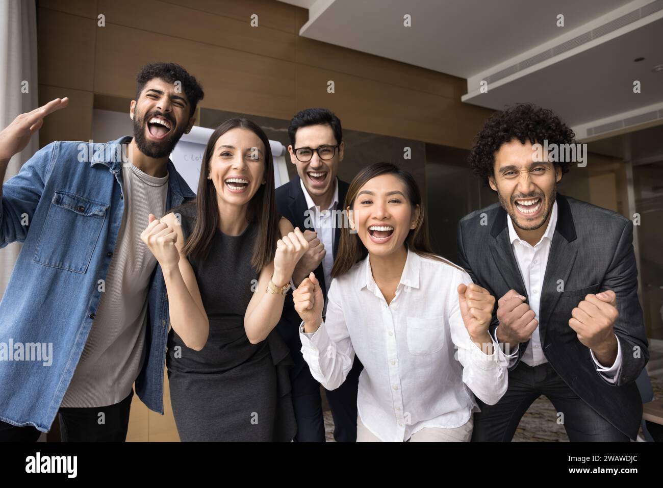 Multiethnic business team of excited project colleagues celebrating ...