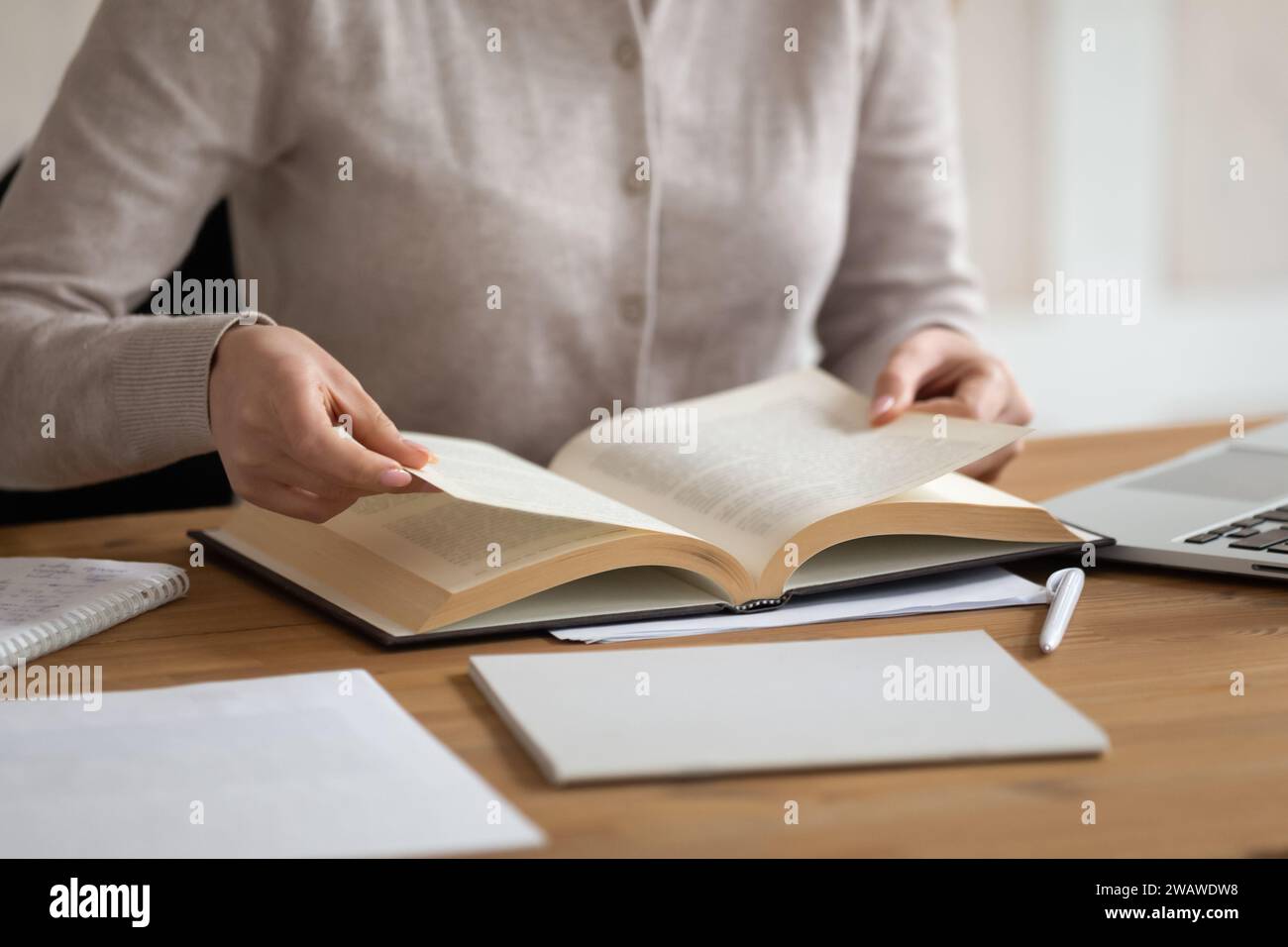 Female student busy studying reading book in classroom Stock Photo - Alamy