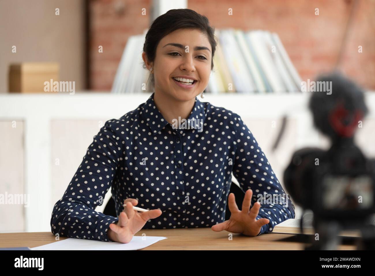 Millennial indian female coach recording video training course Stock Photo - Alamy