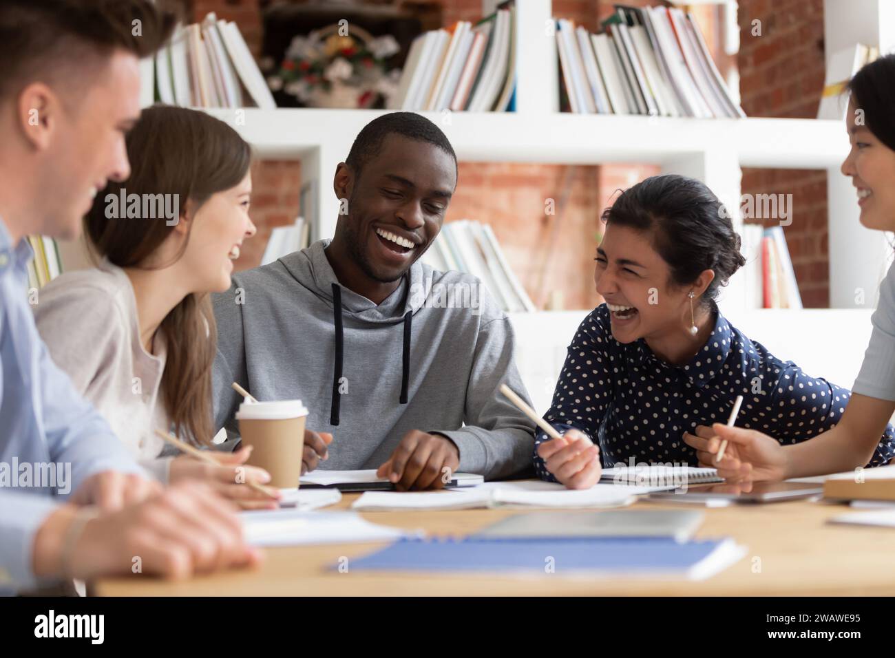 Smiling multiethnic students laugh studying in classroom together Stock Photo - Alamy