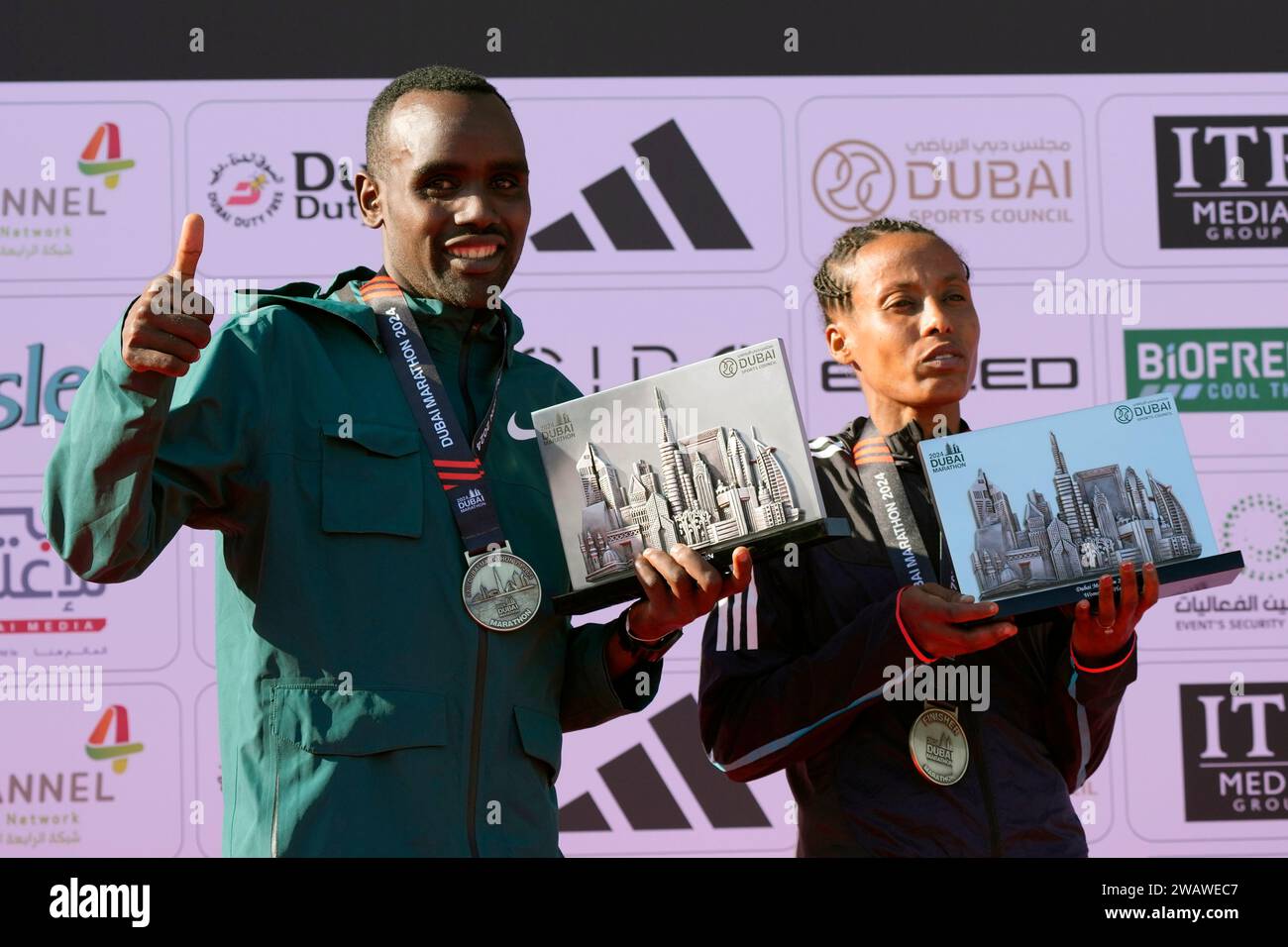 Addisu Gobena, left, and Tigist Ketema, both from Ethiopia, celebrate ...