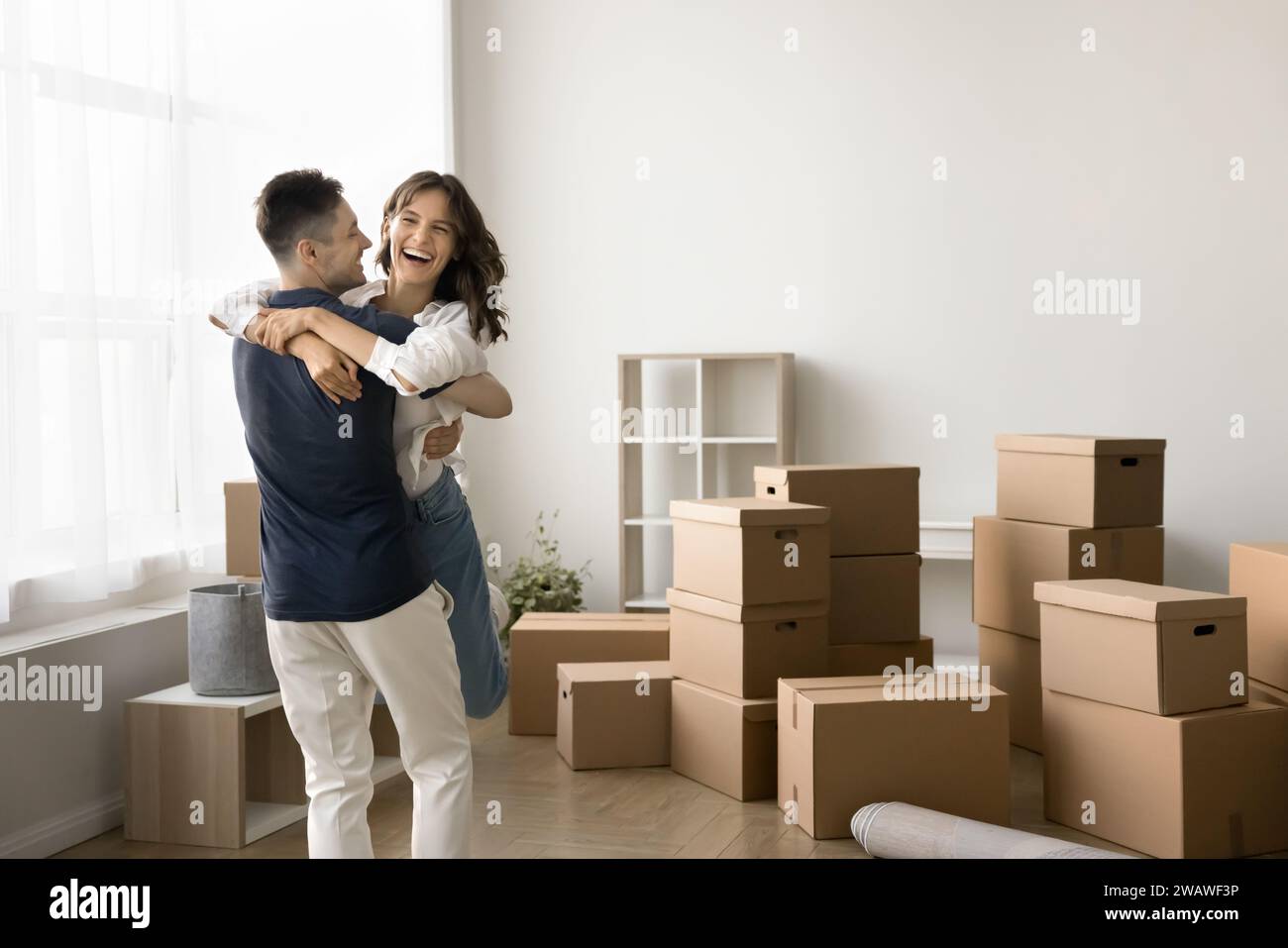 Happy married couple enjoying first relocation, moving activities Stock ...