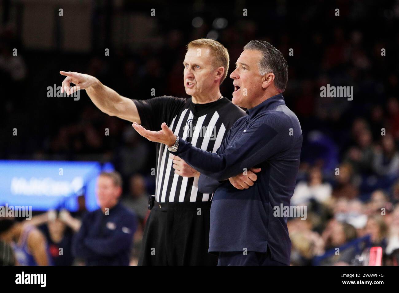 San Diego head coach Steve Lavin, right, speaks with an official during ...