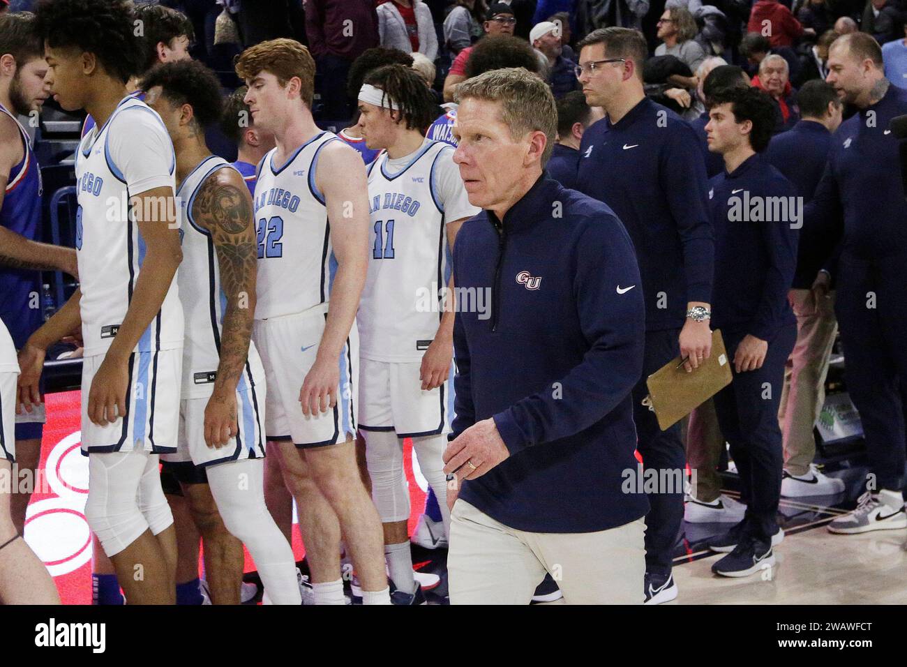 Gonzaga head coach Mark Few, center, walks on the court after an NCAA ...