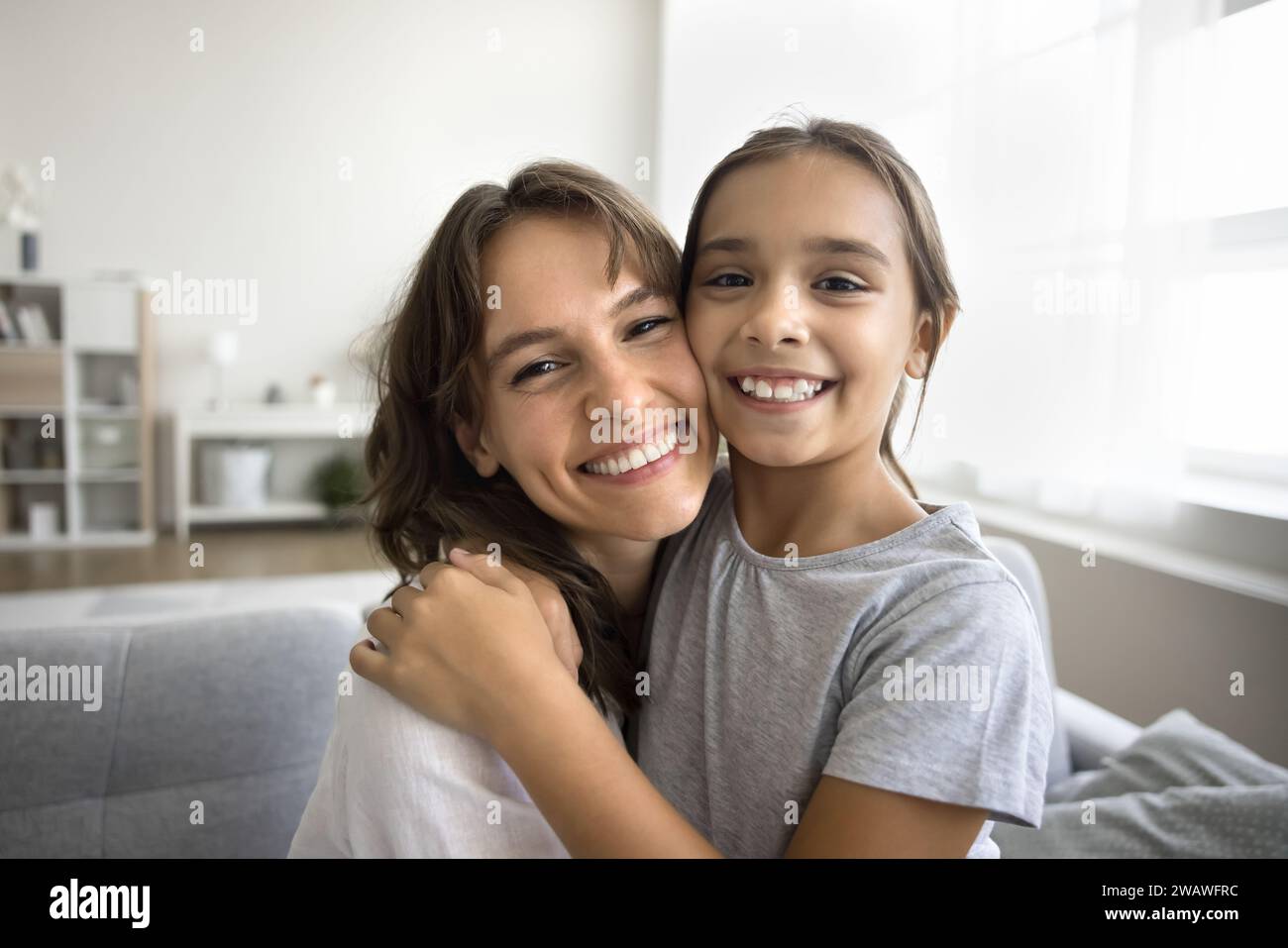 Cheerful mom and happy tween daughter kid hugging with love Stock Photo - Alamy