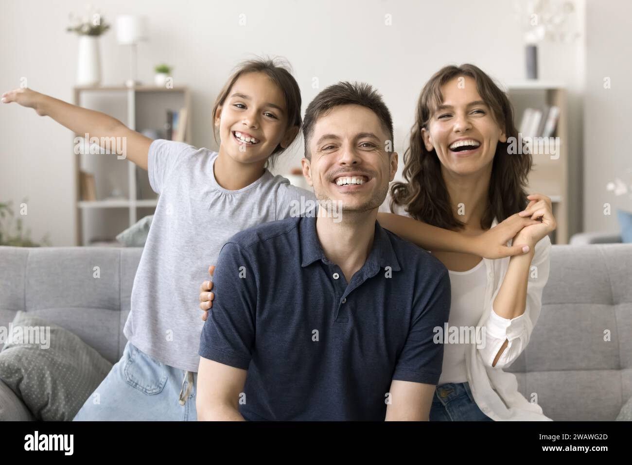 Cheerful happy parents and kid with open arms having fun Stock Photo ...