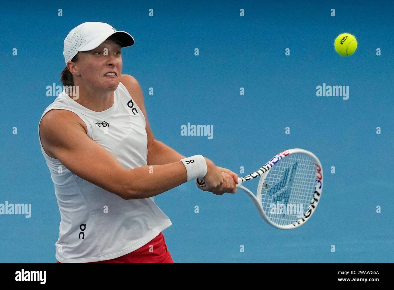 Poland's Iga Swiatek plays a backhand return to Germany's Angelique ...