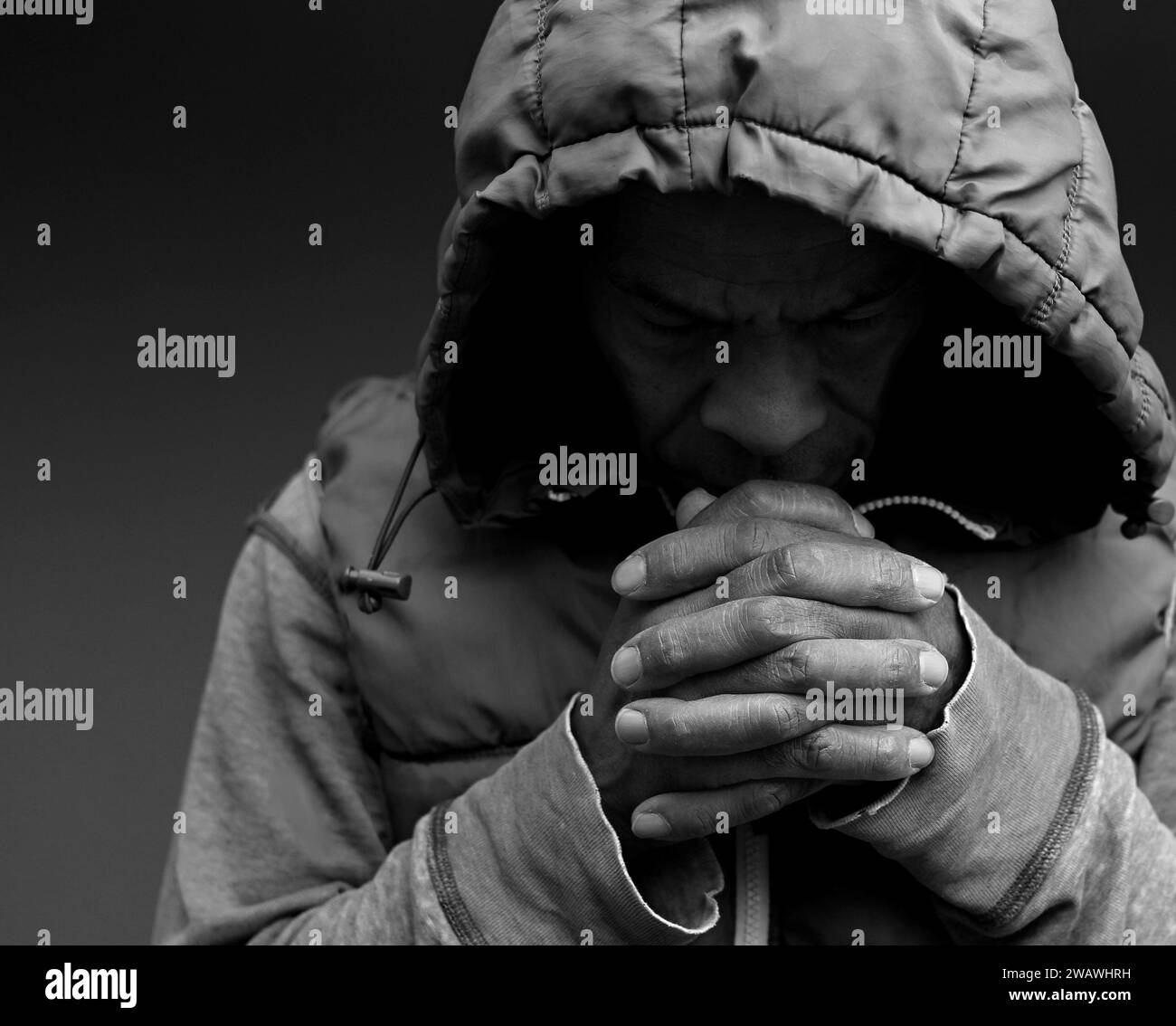 praying to god for forgiveness Caribbean man praying with grey black ...