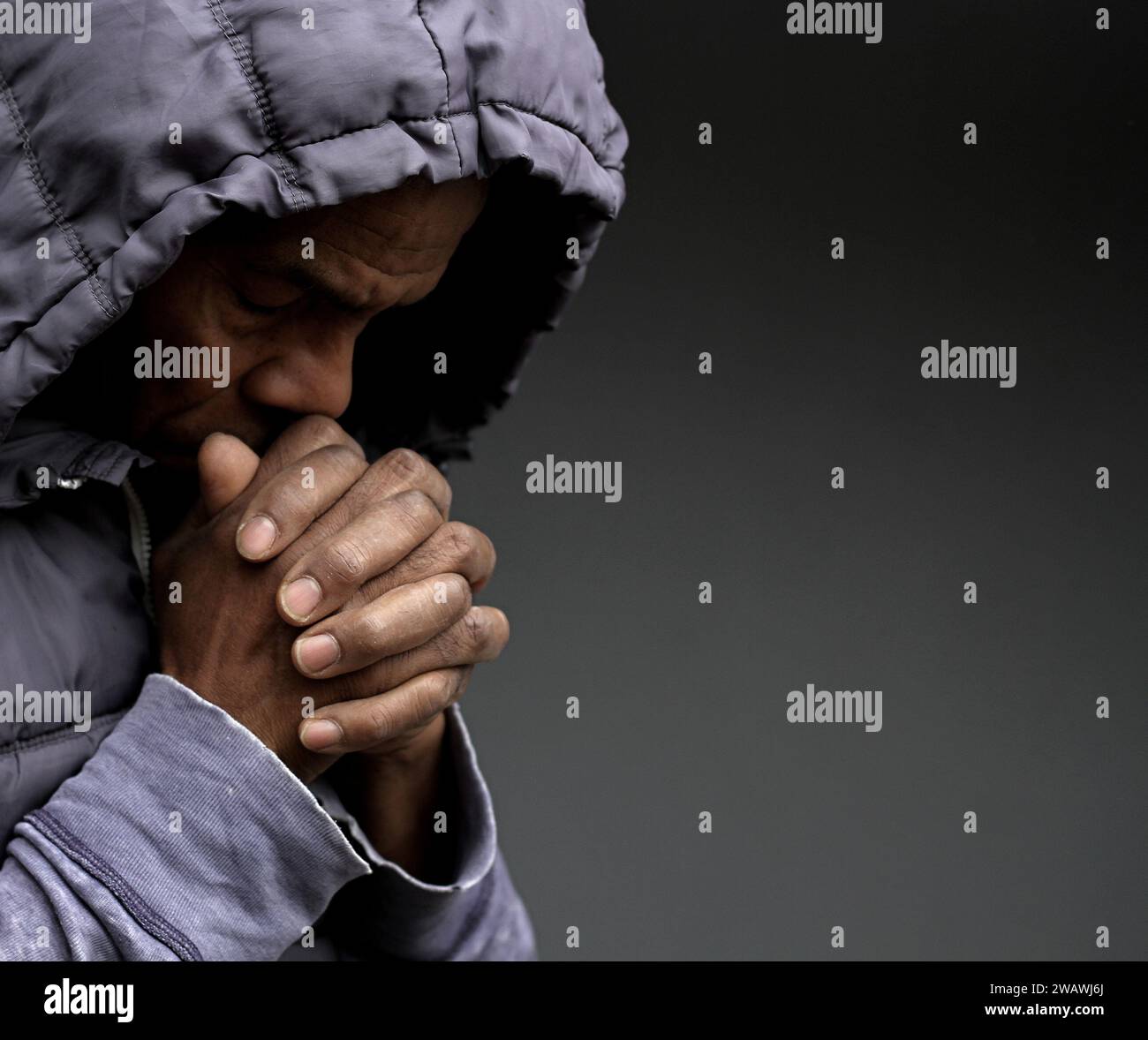 praying to god for forgiveness Caribbean man praying with grey black ...