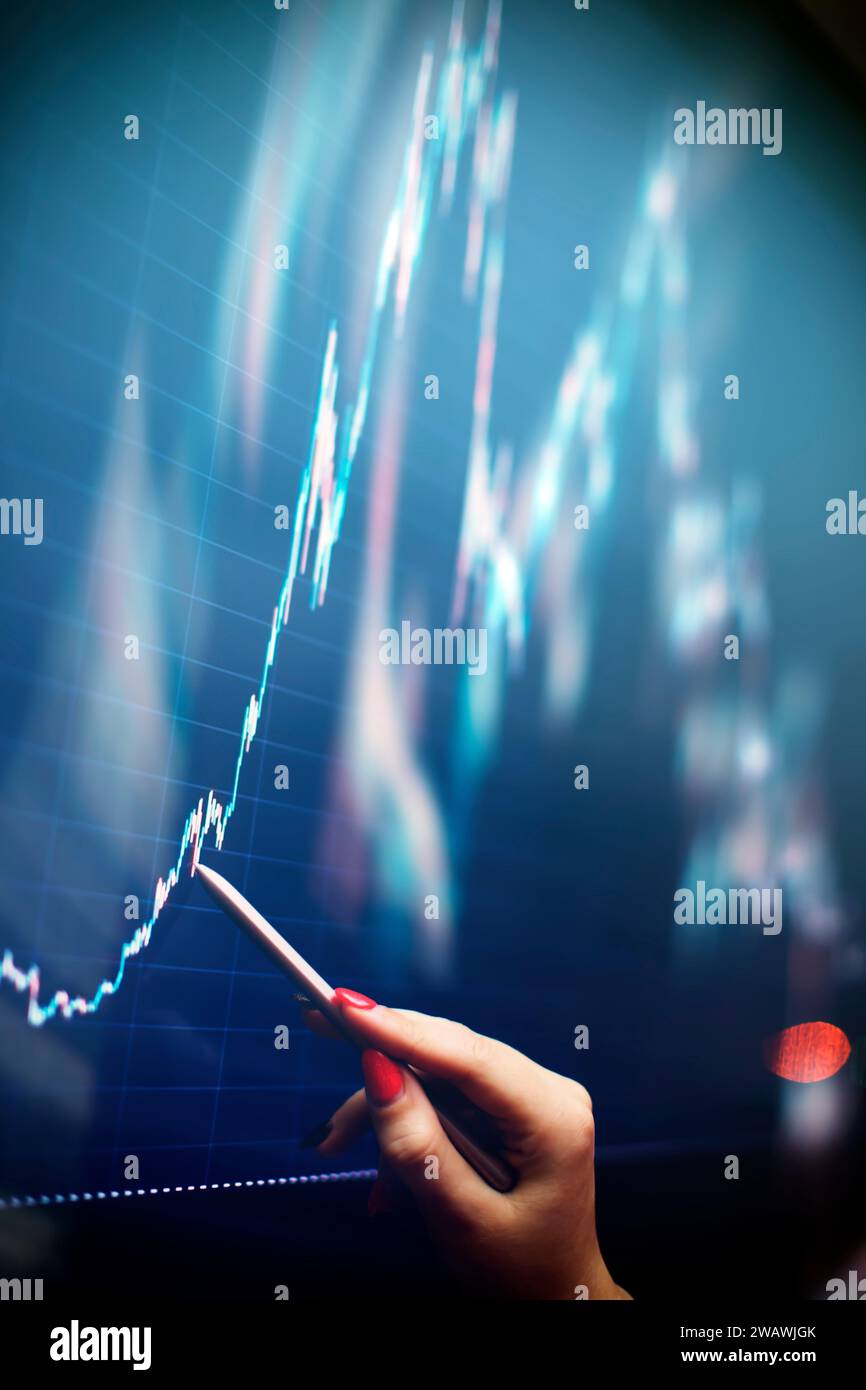 Businesswoman manually drawing a diagram on a touch screen interface ...