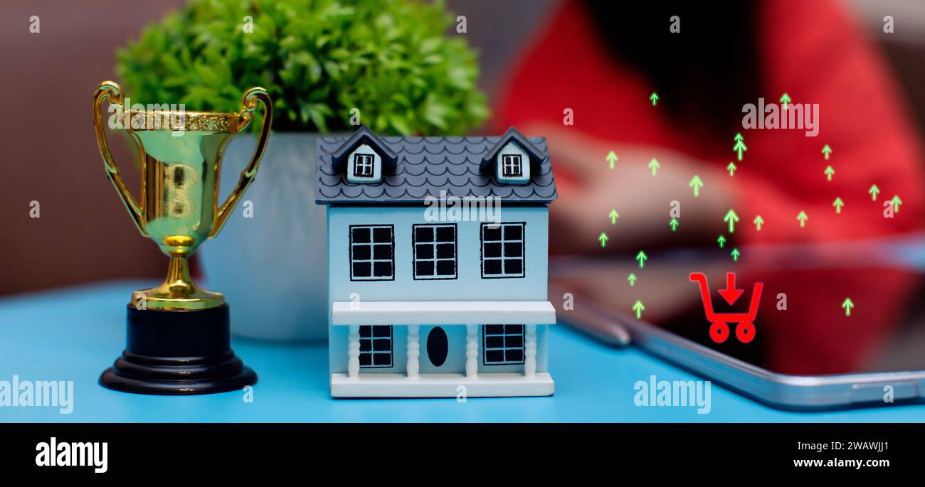 House model, trophy and smartphone. Real estate investment Stock Photo ...