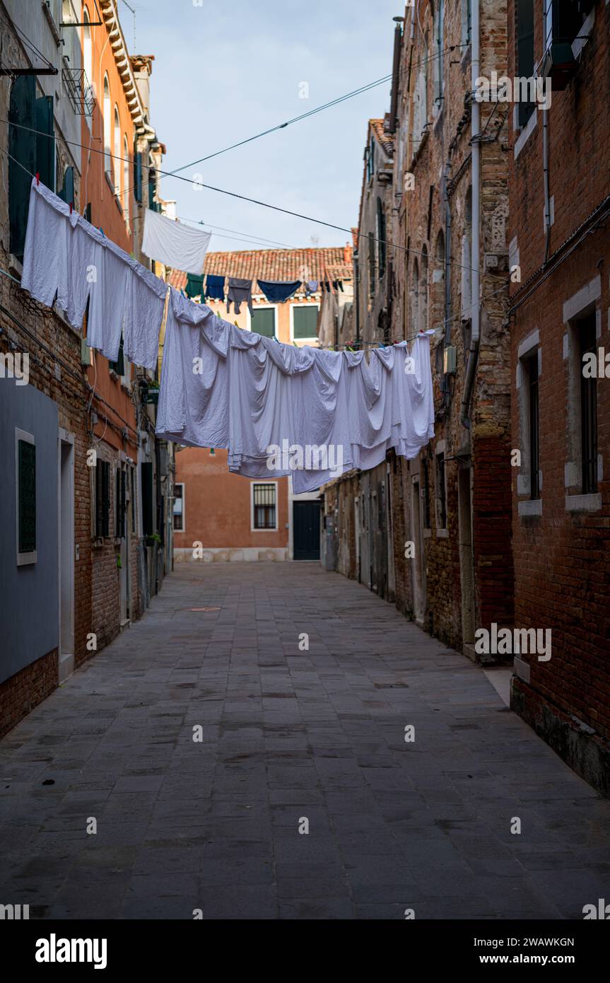A washing line with sheets typically stretched between the houses in ...