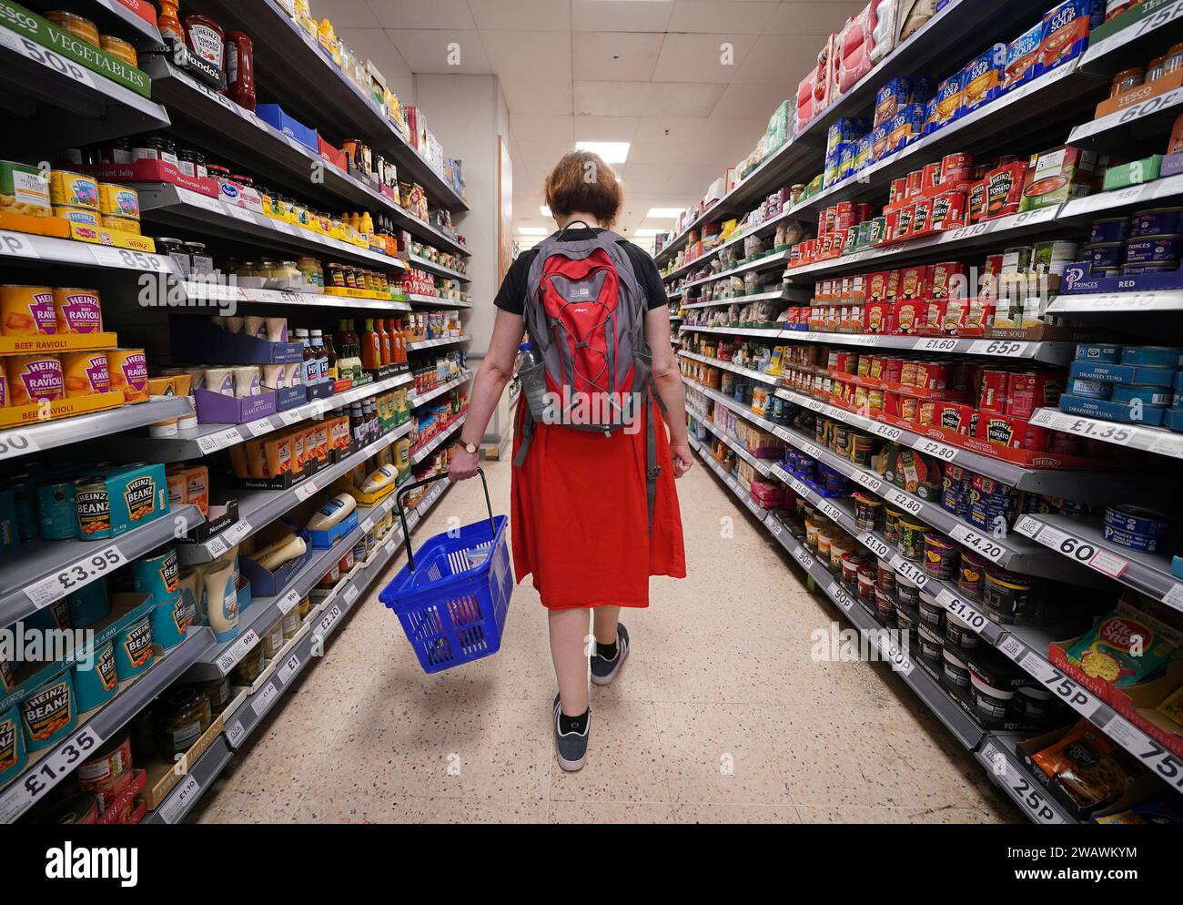 File photo dated 03/09/22 of a shopper walking through the aisle of a ...