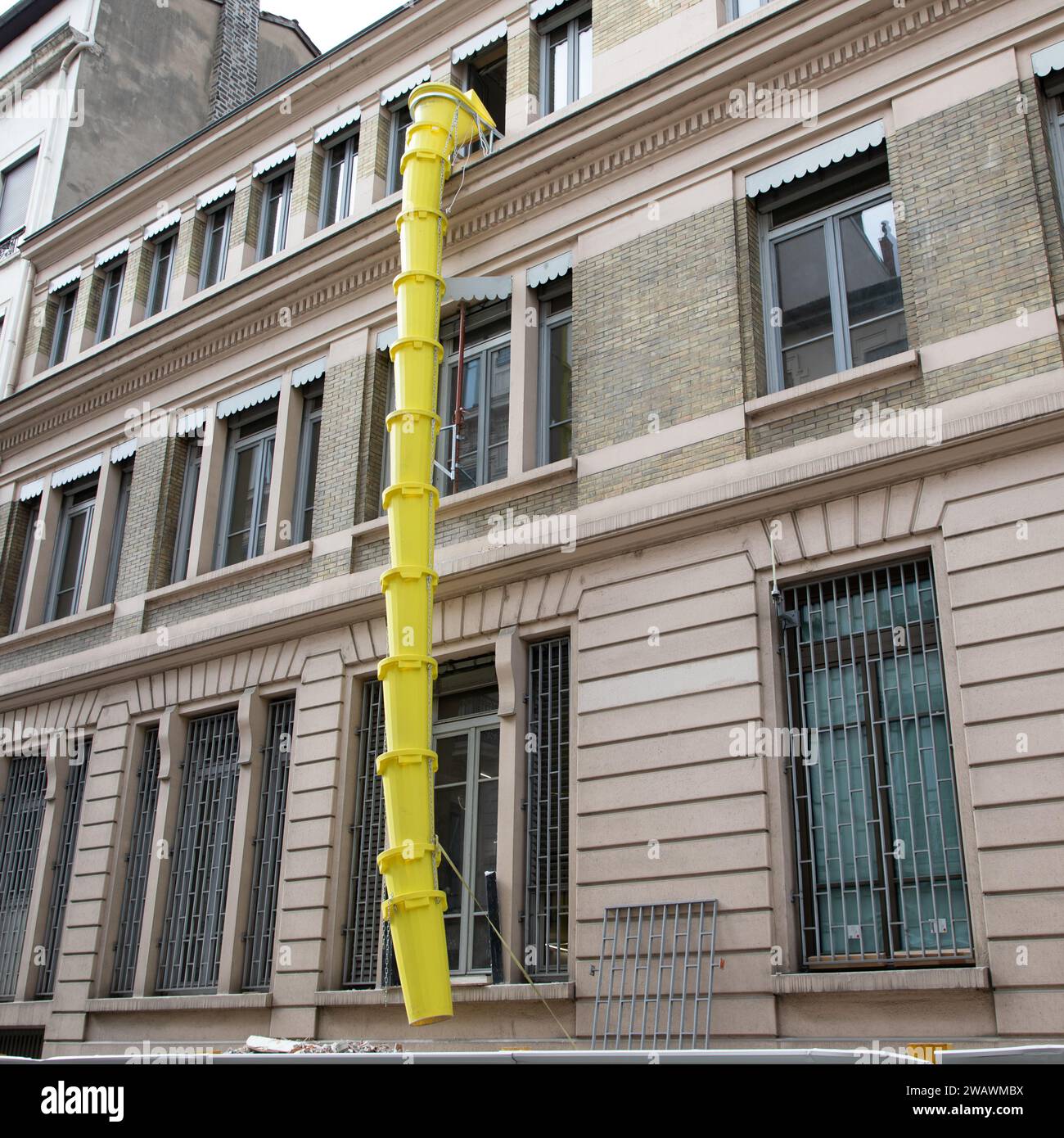 plastic slide chute yellow for rubble debris removal on building facade ...