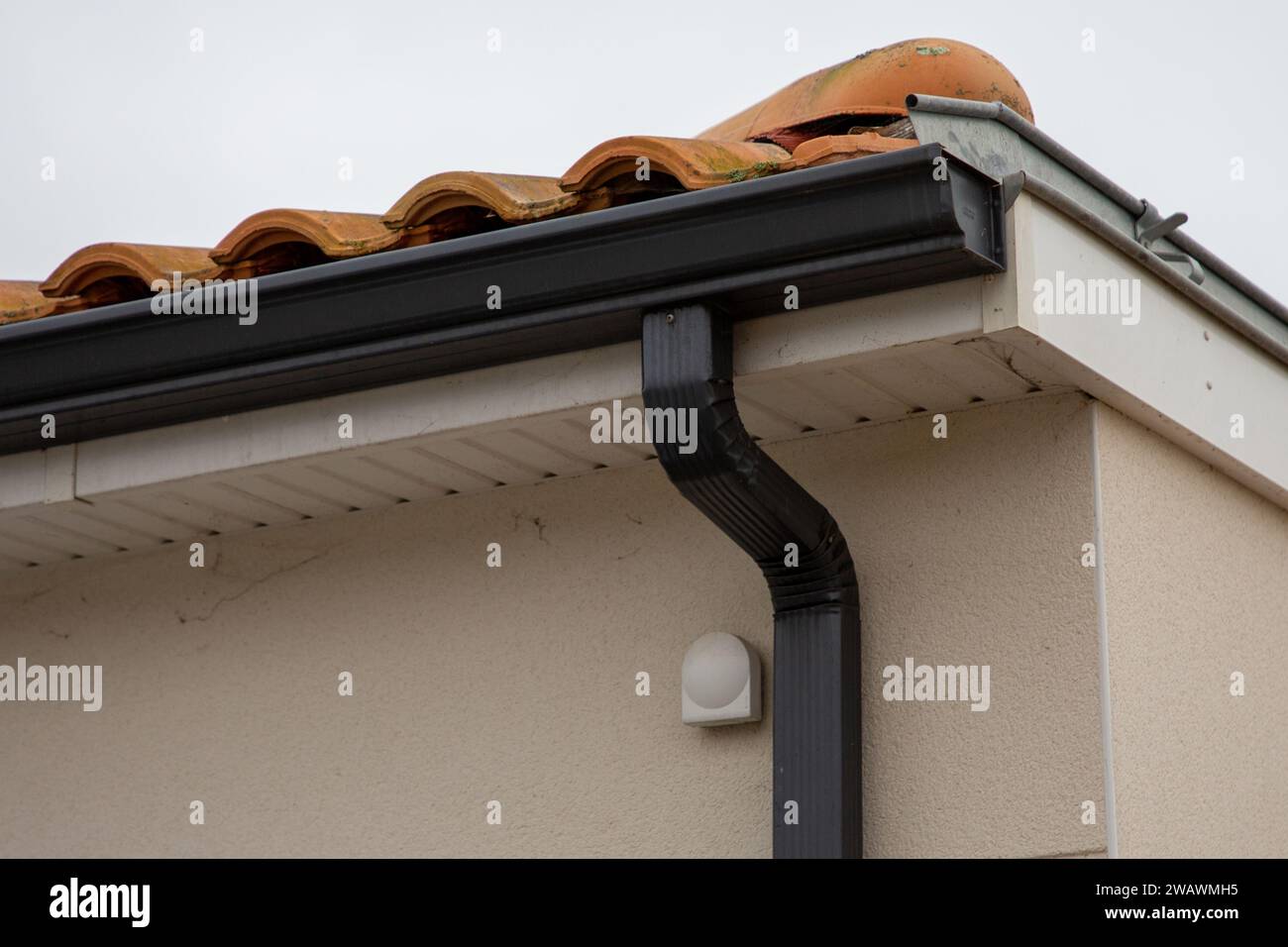 metal black aluminum gutter rain systems on home roof covered with ...