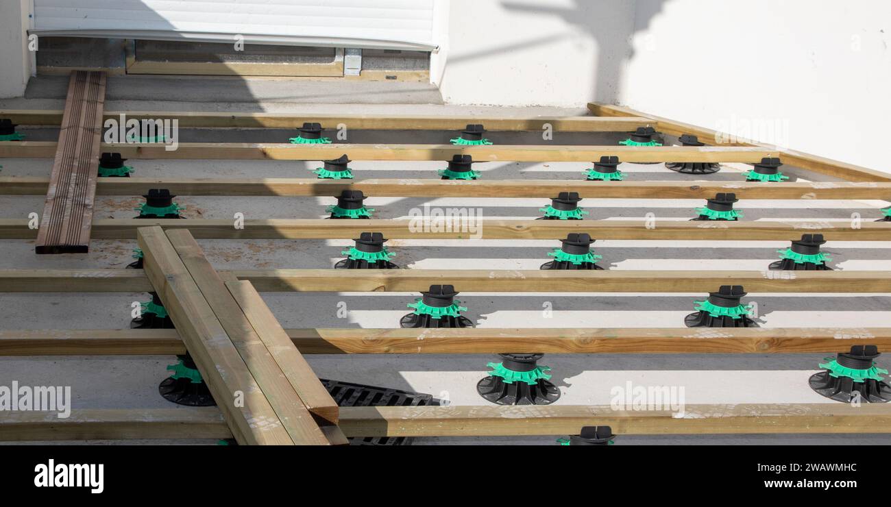 exotic wooden terrace installed on adjustable screw level stud plastic ...