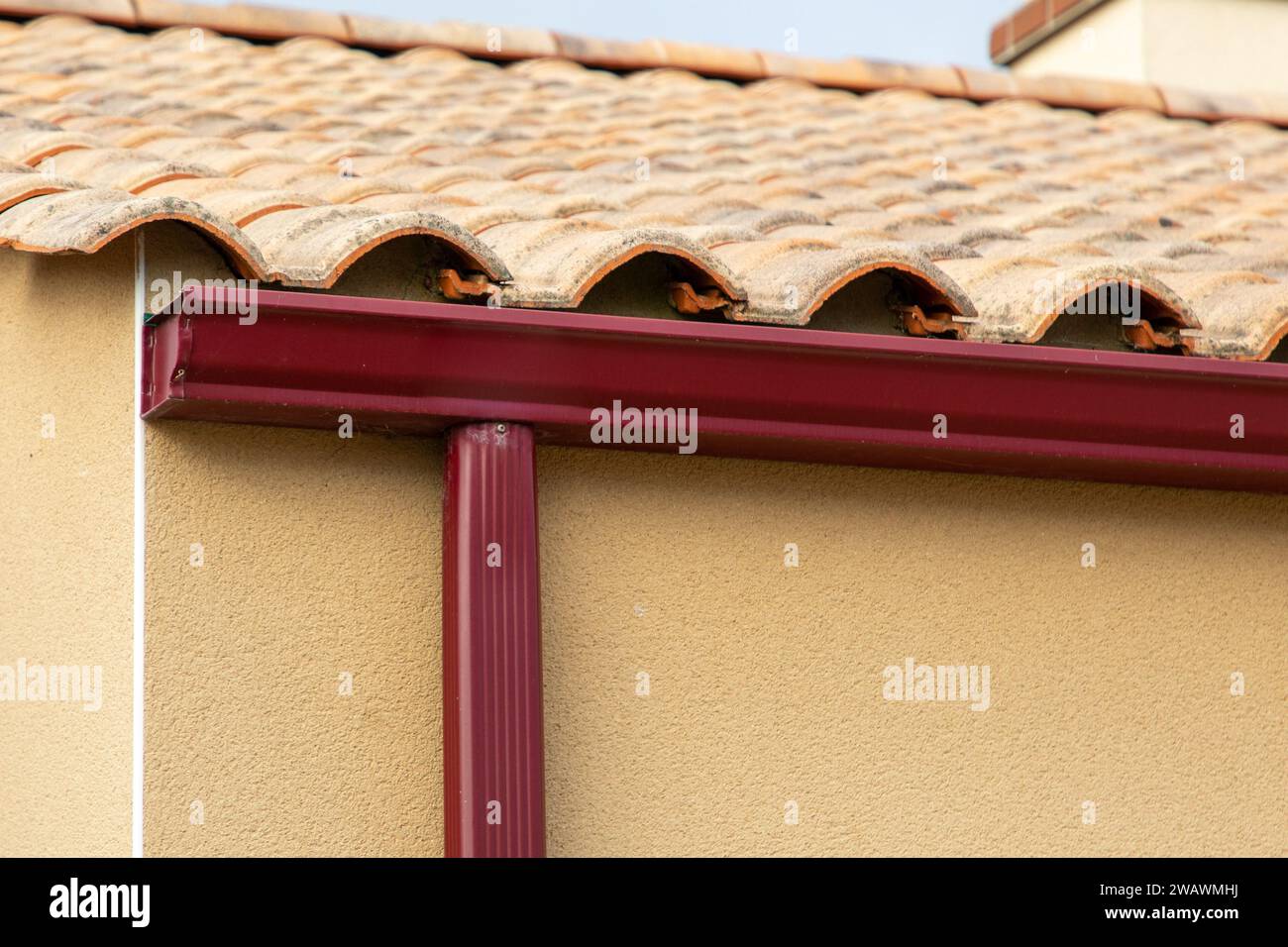 Roof showing red gutters aluminium guttering and down pipe on new house ...