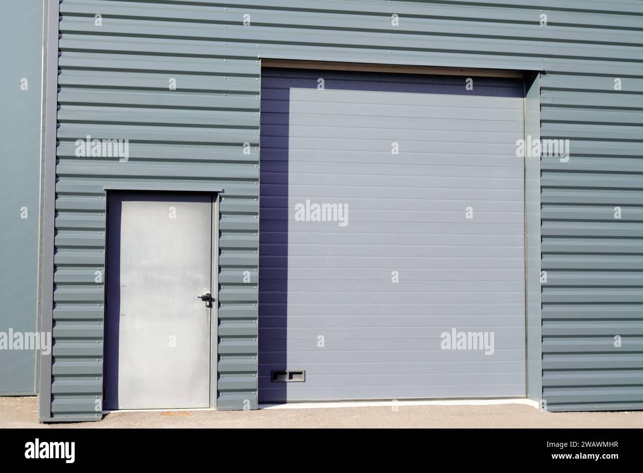 entrance roll-down facade shutters on gray building fire exit door in ...
