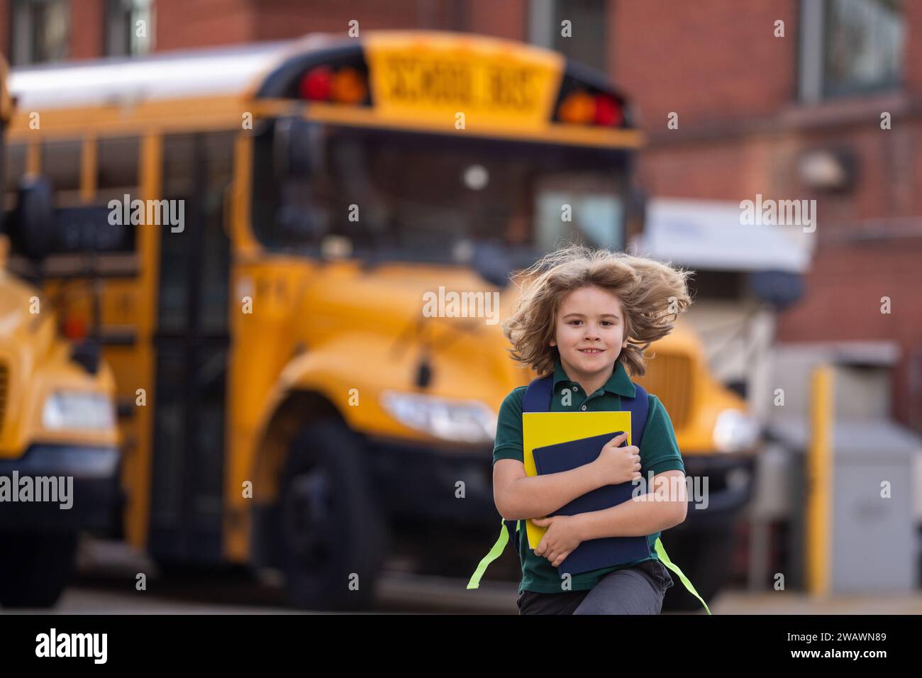 Schoolkid getting on the school bus. American School. Back to school ...