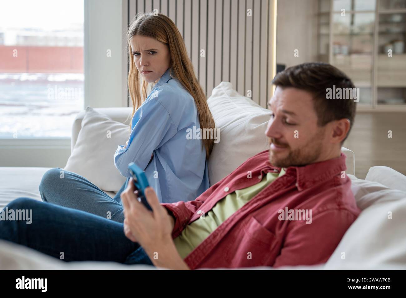 Annoyed woman angry at husband social media addiction with smile ...