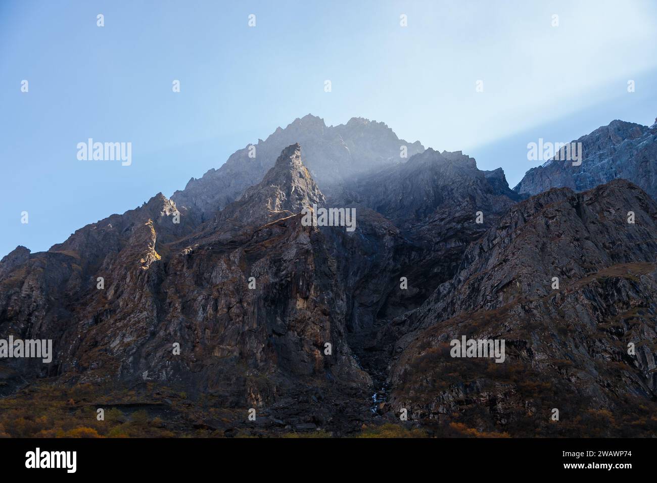 A breathtaking landscape with majestic rocky mountains, shrouded in the ...