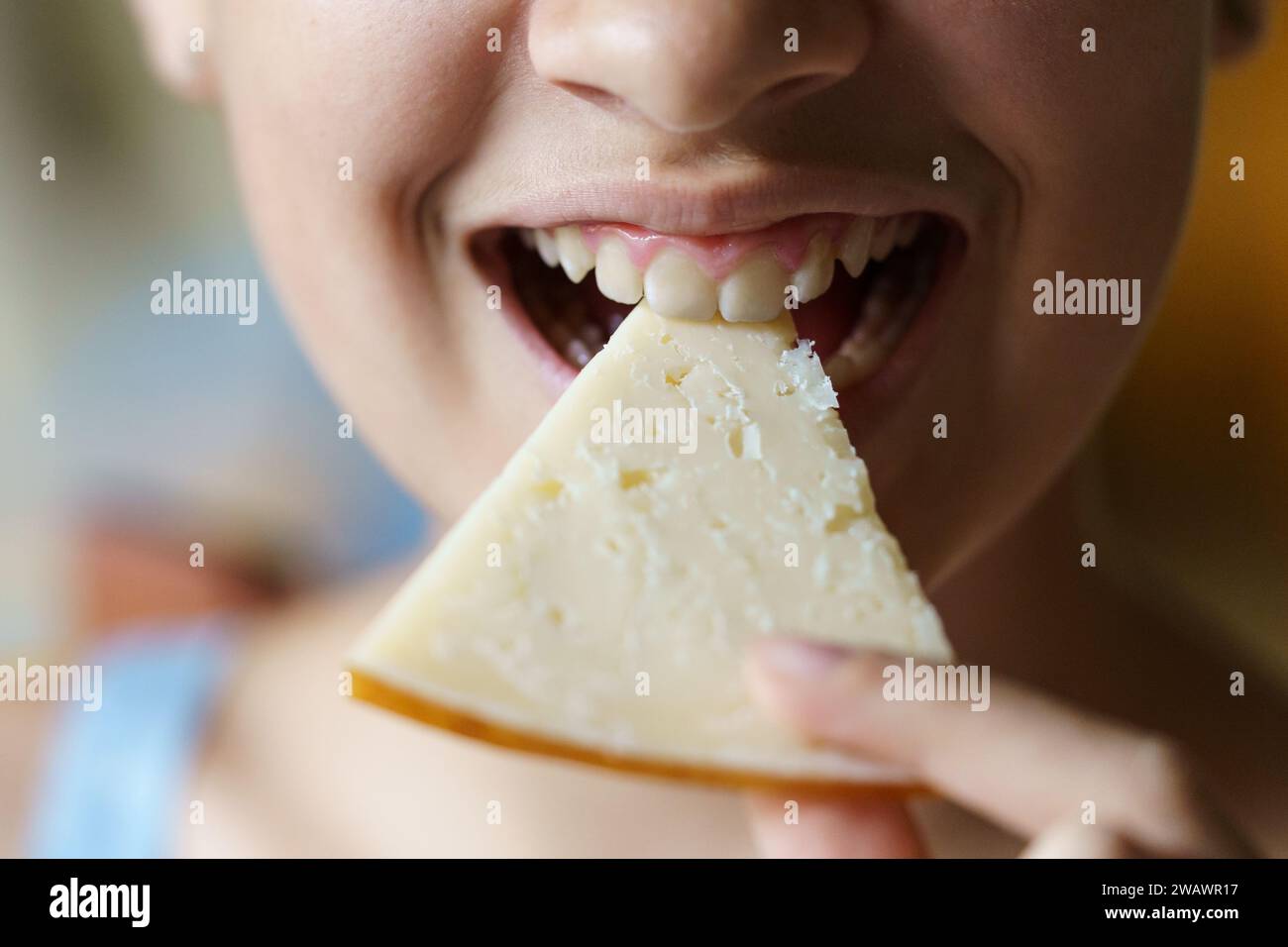 Anonymous teenage girl eating fresh cheese slice Stock Photo - Alamy