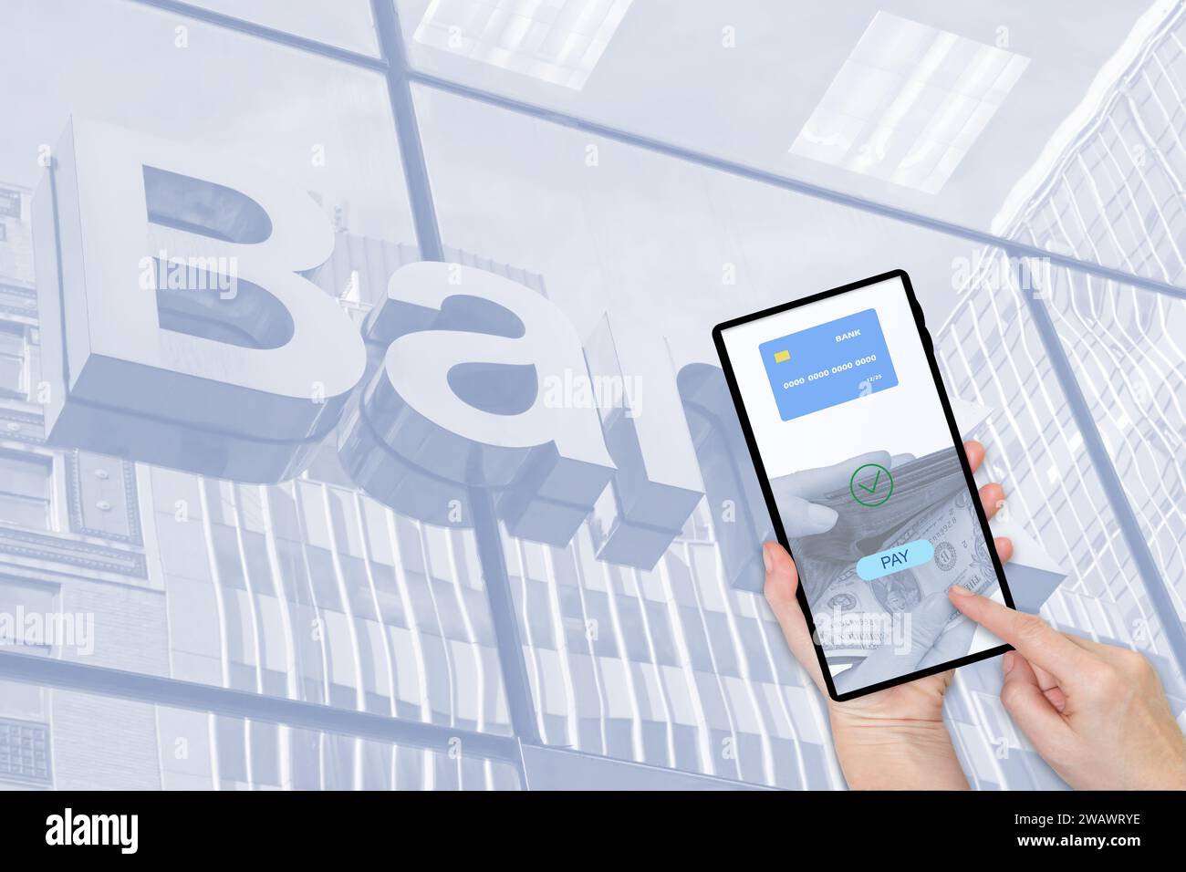 Hands holding smartphone with bank in background. Online shopping ...