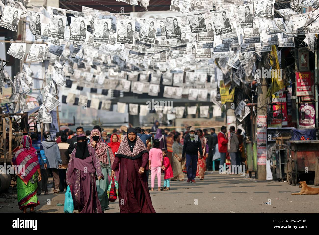 People arrive at a polling center to cast their votes for the 12th ...